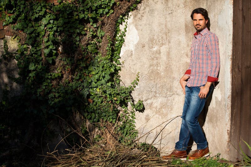 Male Model Leaning Against Wall Stock Image - Image of suave, male ...
