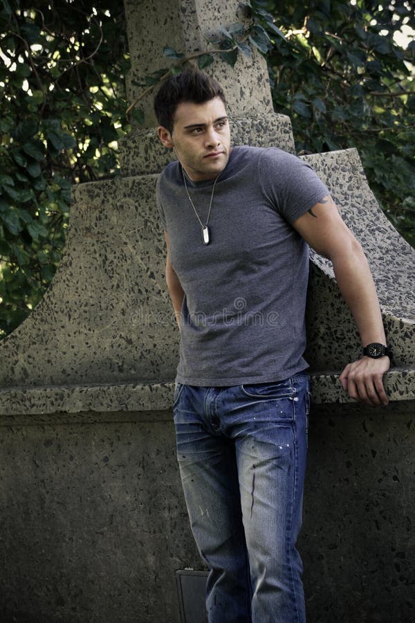 Male Model Leaning on a Stone Wall. Stock Photo - Image of wearing ...