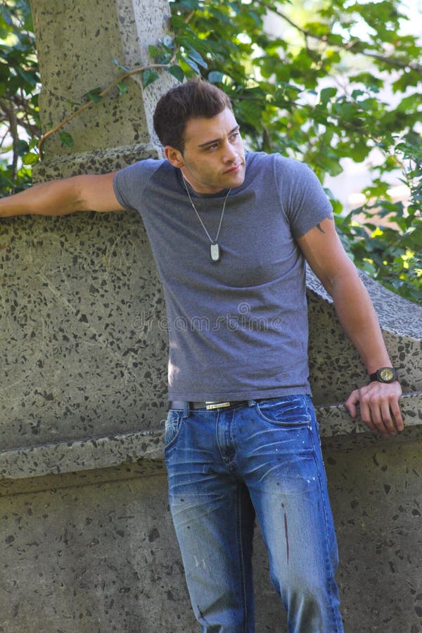 Male Model Leaning on a Stone Wall. Stock Image - Image of wearing ...