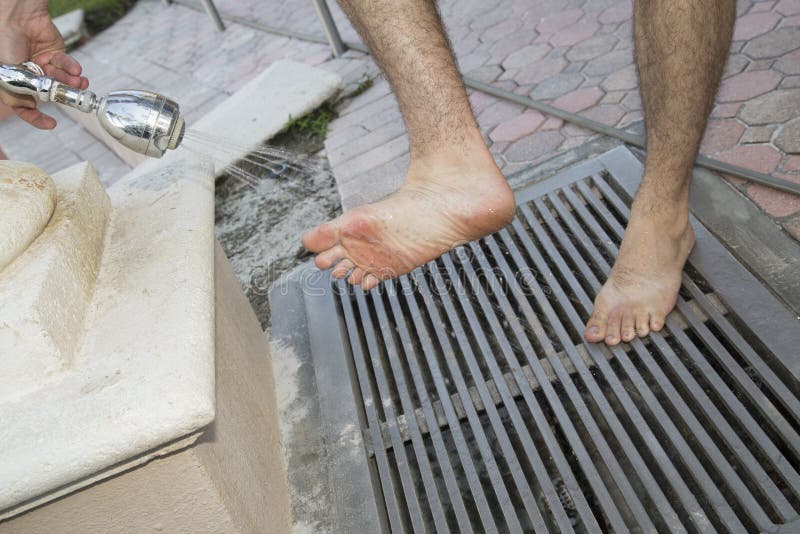 Male Model Washing His Feet at the Side of a Pool or Lake Stock Image ...