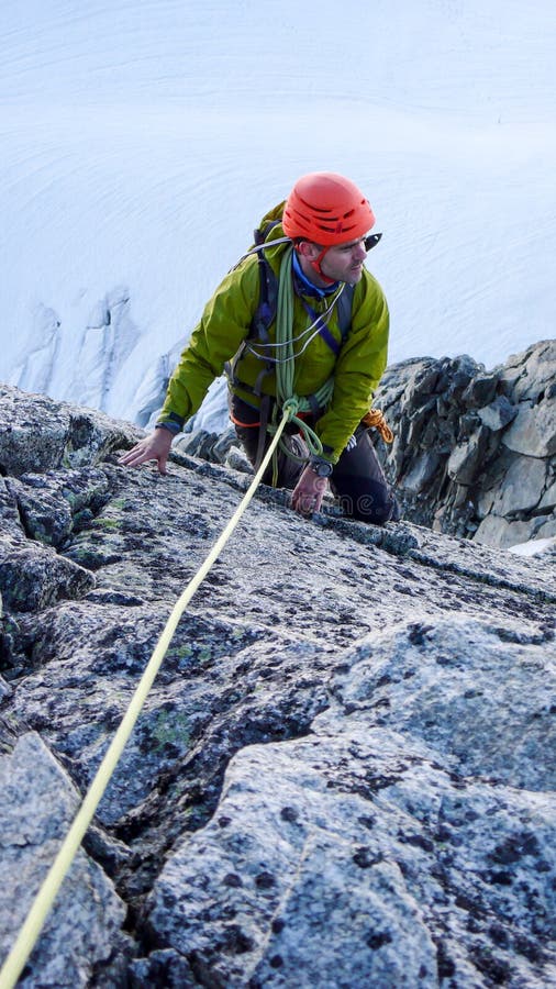 Male Mountain Guide Lead Climbing on an Exposed Granite Ridge in the ...