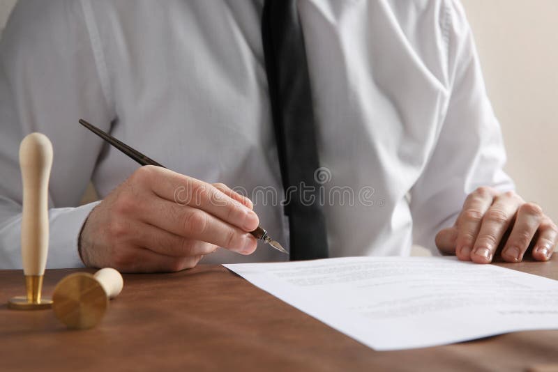 Notary Signing a Contract with Fountain Pen in Dark Room Stock Photo ...
