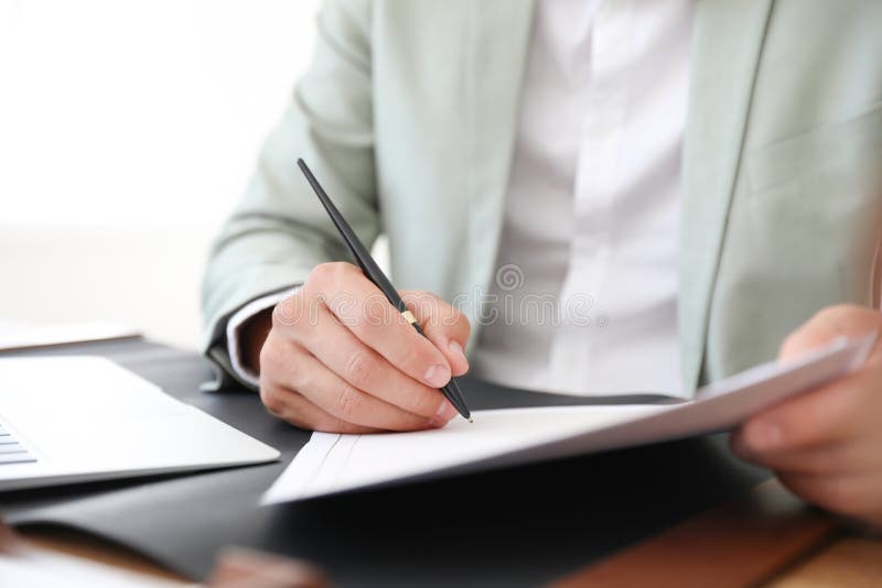 Male Notary Signing Document at Table in Office Stock Image - Image of ...