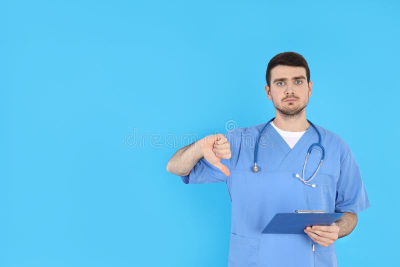 Male Nurse with Clipboard on Blue Background Stock Photo - Image of ...
