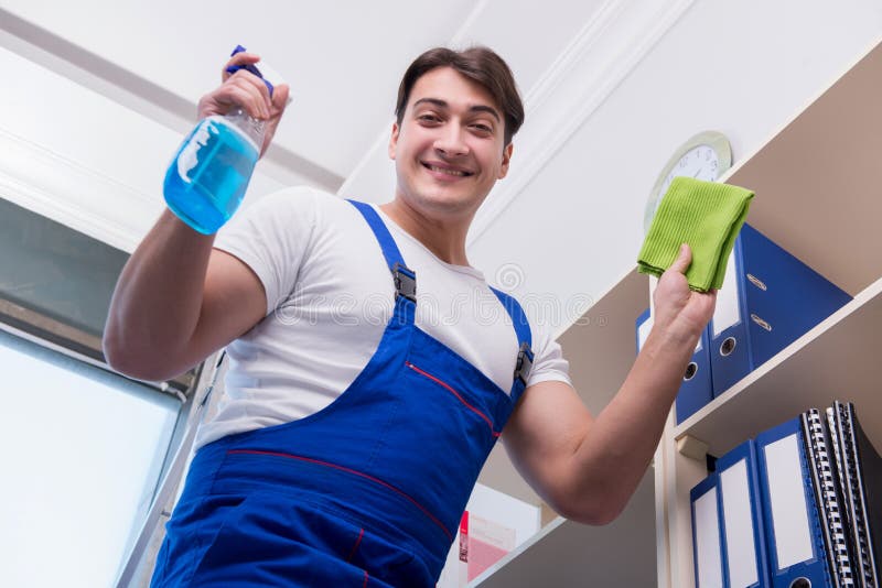 The Male Office Cleaner Cleaning Shelves in Office Stock Photo - Image ...