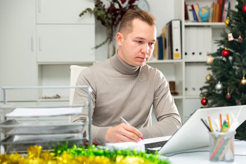 Male Office Worker Doing Paperwork during Christmastime Stock Photo ...