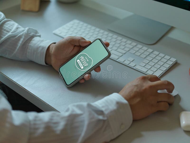 Male Office Worker Using Mock Up Smartphone while Working with Computer ...