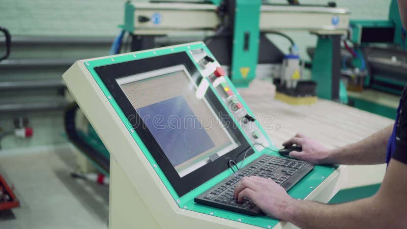 A Male CNC Machine Operator is Typing on the Control Panel. Stock ...