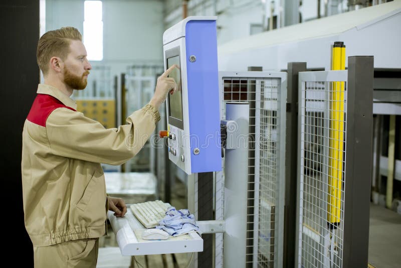 Male Operator Presses the Button on the Control Panel at the Control ...