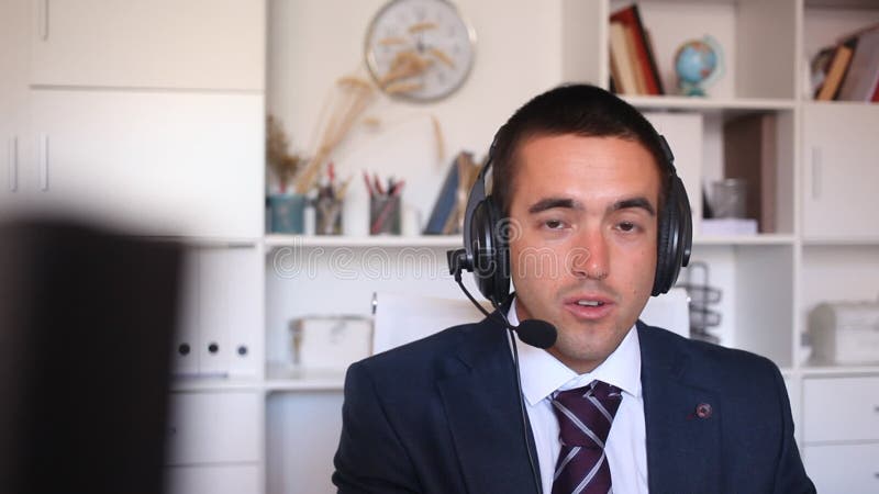 Male Operator Talking with Customer Using Headset at Company Office ...