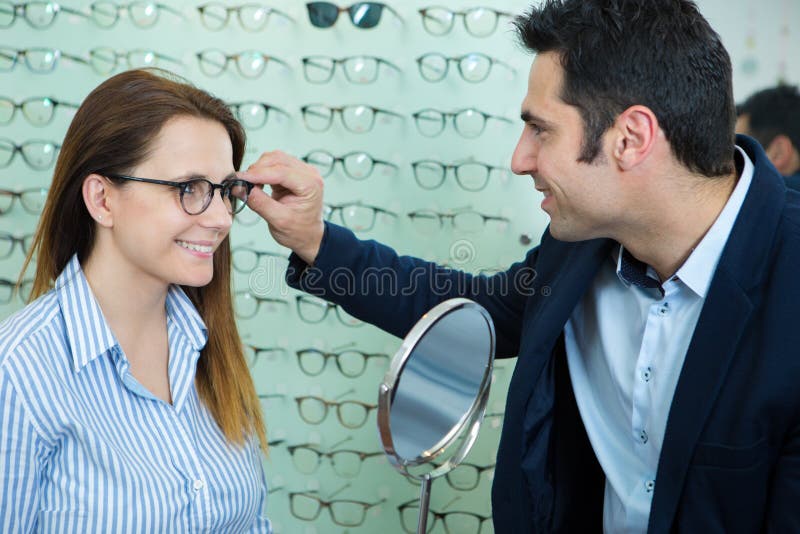 Male Optician Checking Fit Glasses on Female Customer Stock Image ...