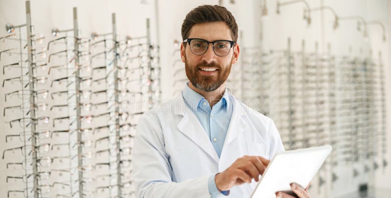 Male Optician with Digital Tablet on Background of Shop Windows with ...