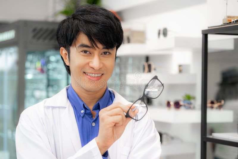Male Optician Standing with a Eyeglasses in Optical Store Stock Photo ...