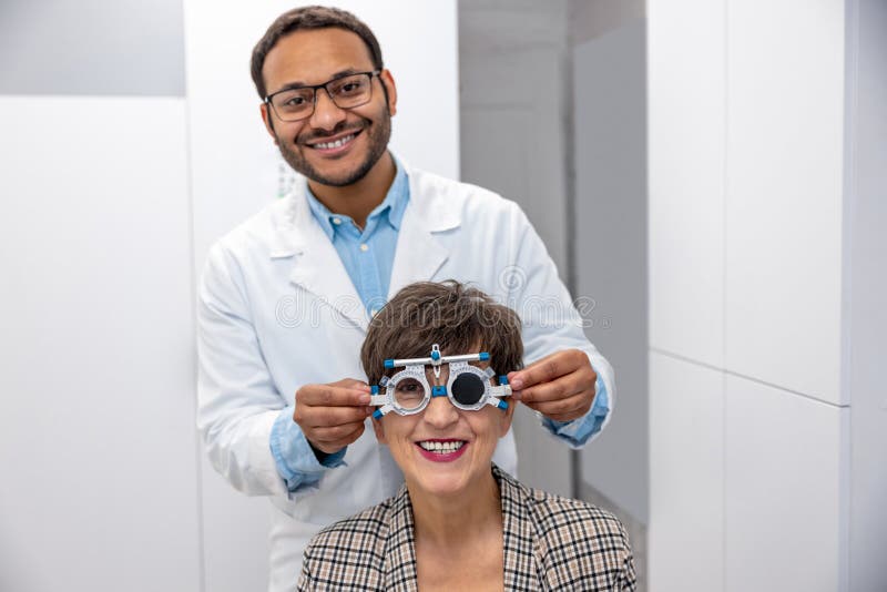 Male Optometrist Checking Eyesight of a Female Visitor Stock Photo ...