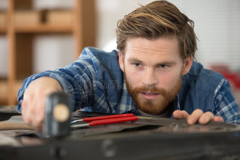 Male Panel Beater Using Mallet on Car Bodywork Stock Photo - Image of ...