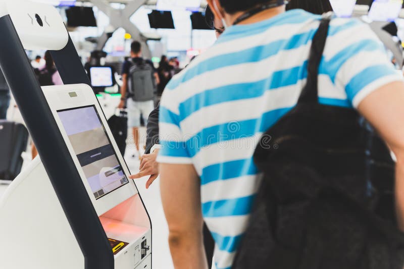 Male Passenger with Backpack Doing Self Check in for Flight at ...