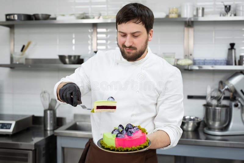 Male Pastry Chef Holds a Cut Mousse Cake in His Hands. Stock Photo ...