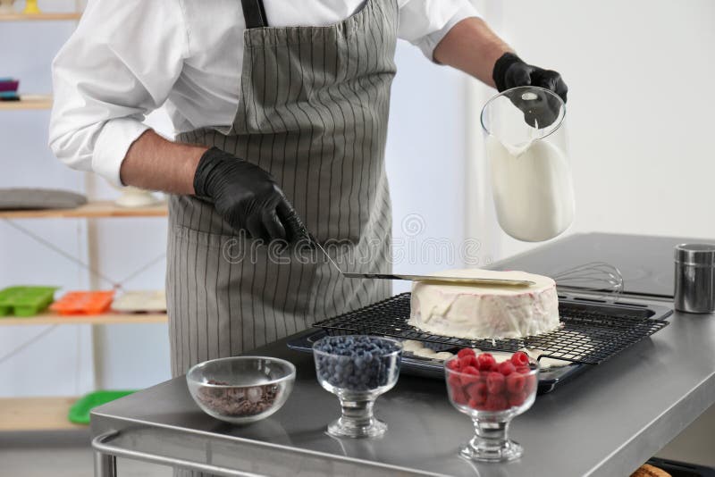 Male Pastry Chef Preparing Cake at Table in Kitchen Stock Photo - Image ...