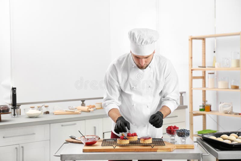 Male Pastry Chef Preparing Desserts at Table Stock Photo - Image of ...