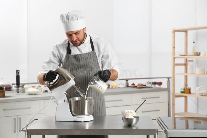 Male Pastry Chef Preparing Dough in Mixer at Table Stock Image - Image ...