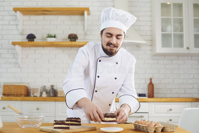 A Male Pastry Chef Works Decorating a Cake on a Kitchen Bakery Stock ...