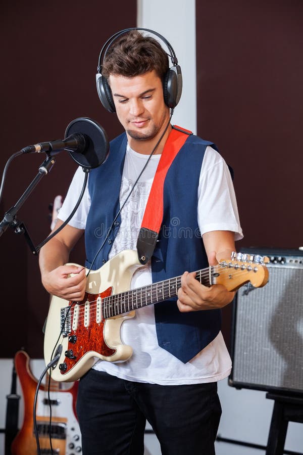 Male Performer Playing Electric Guitar in Studio Stock Photo - Image of ...