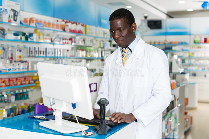 Male Pharmacist Working on Pc Stock Photo - Image of inventorying ...