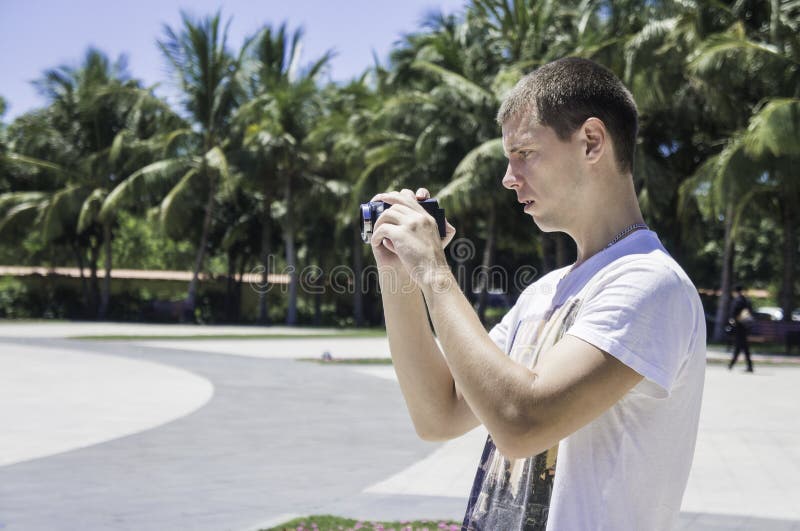 Male Photographer, Side View of a Man Holding Camera in His Hands Stock ...