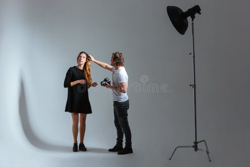 Male Photographer Working with Female Model in Studio Stock Photo ...
