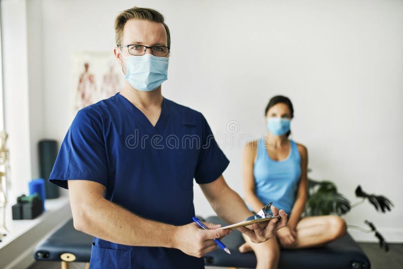Male Physical Therapist with Female Patient on the Back Stock Photo ...