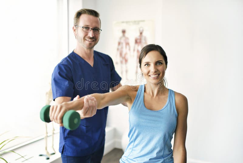 Male Physical Therapist Stretching a Female Patient Stock Photo - Image ...