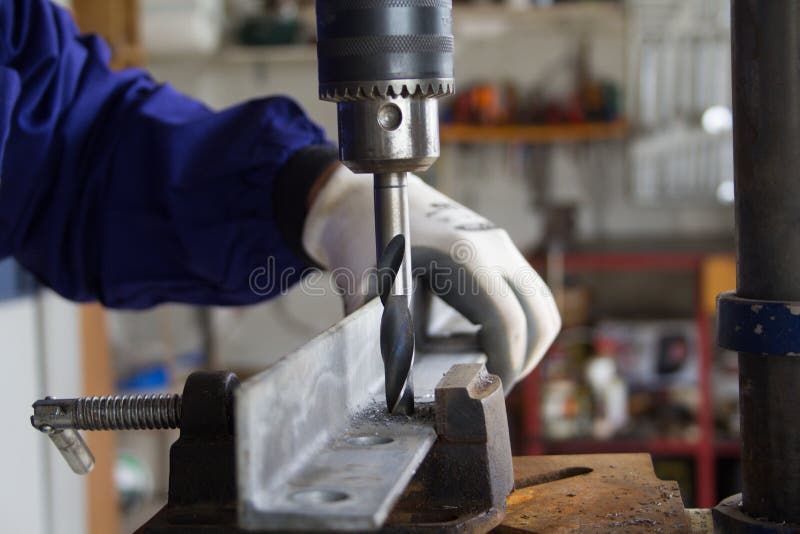 Male Piercing an Iron Piece with a Drill in the Construction Site Stock ...