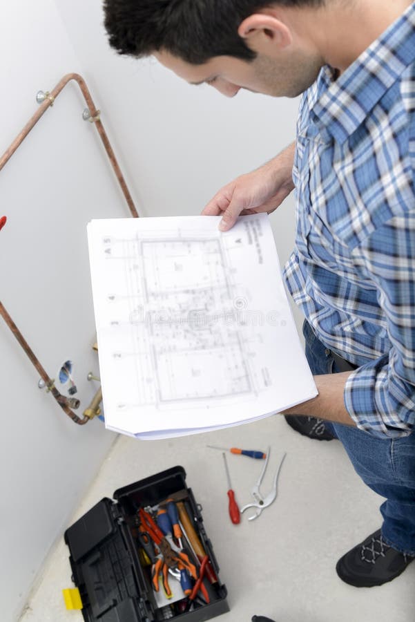 Male Plumber Checking Plans Stock Image - Image of service, contractor ...