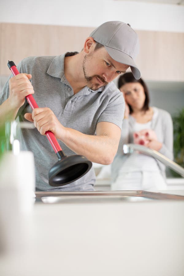 Male Plumber Using Plunger in Kitchen Sink Stock Image - Image of ...