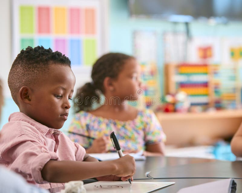 Male Primary or Elementary School Student at Desk in Classroom Stock ...