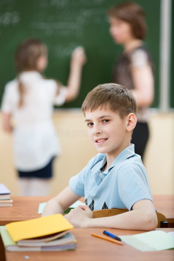 Male Primary School Student in Classroom with Classmate and Teacher ...
