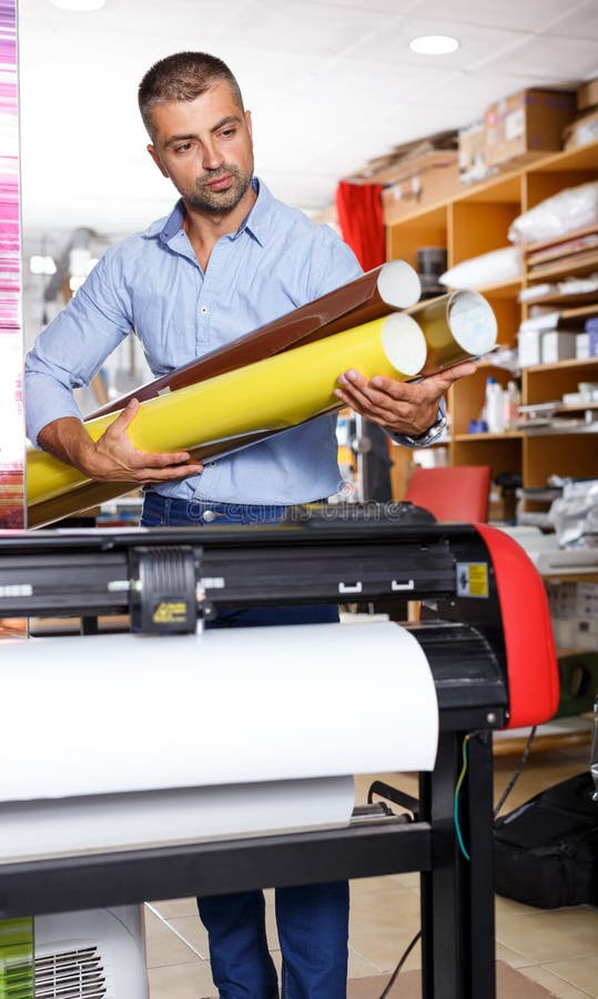 Male Printing Worker with Rolls of Colored Paper Stock Image - Image of ...