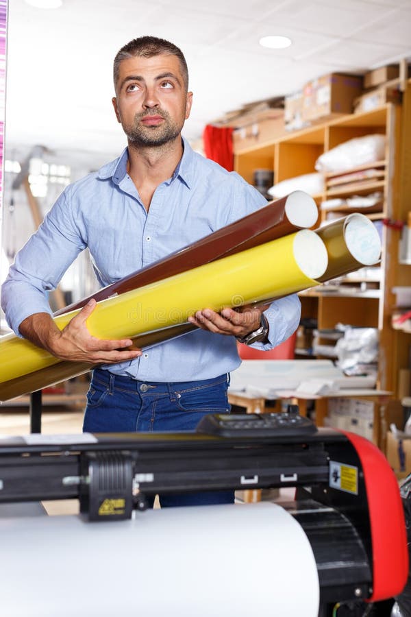 Male Printing Worker with Rolls of Colored Paper Stock Image - Image of ...