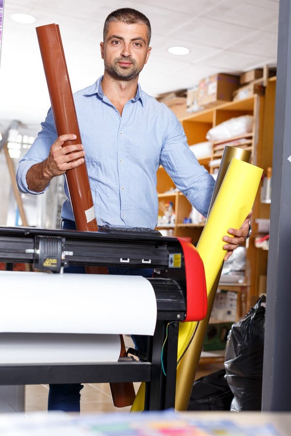 Male Printing Worker with Rolls of Colored Paper Stock Image - Image of ...