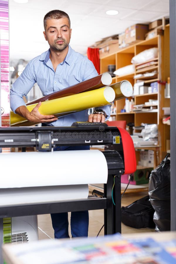 Male Printing Worker with Rolls of Colored Paper Stock Image - Image of ...