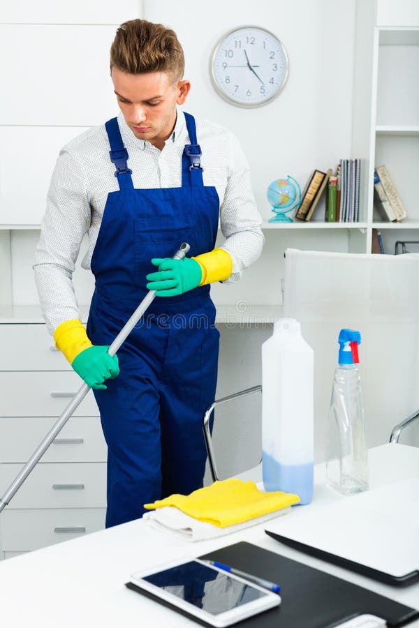 Male Professional Janitor Dusting in Office Stock Image - Image of ...