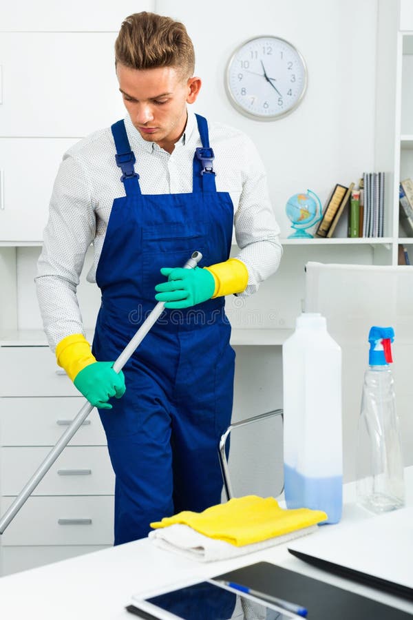 Male Professional Janitor Dusting in Office Stock Image - Image of ...