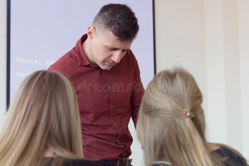 Male Professor Explain Lesson To Students and Interact with Them in the ...