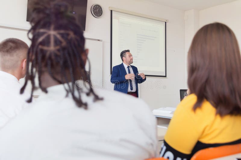 Male Professor Explain Lesson To Students and Interact with Them in the ...