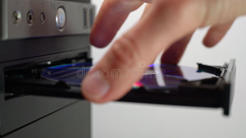 A Male Programmer Takes Out a CD-DVD from a Computer Drive. Side View ...