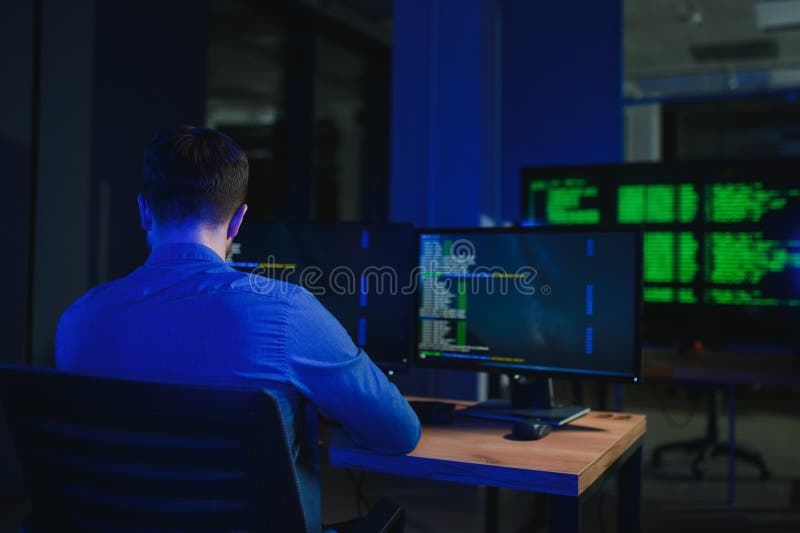 Male Programmer Working on Desktop Computer at White Desk in Office ... Male Programmer Working on Desktop Computer at White Desk in Office ...