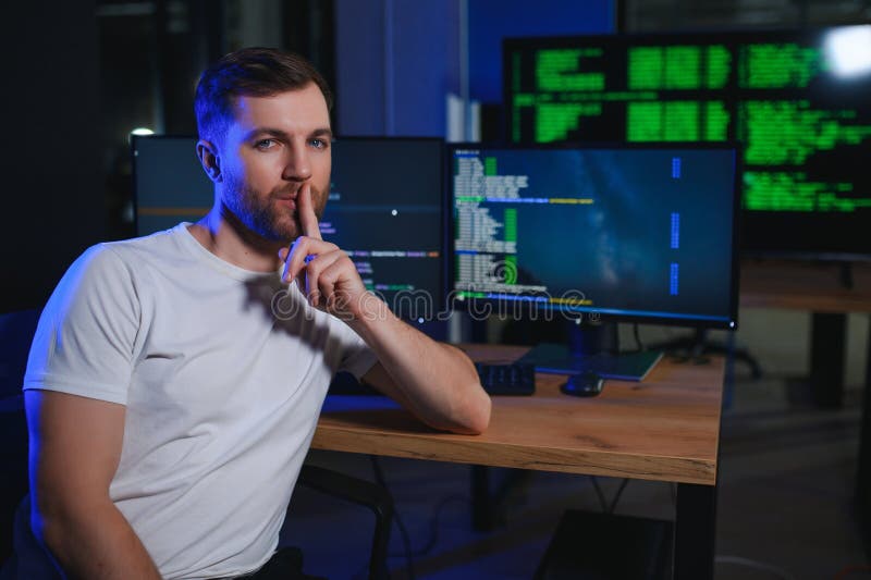 Male Programmer Working On Desktop Computer At White Desk In Office