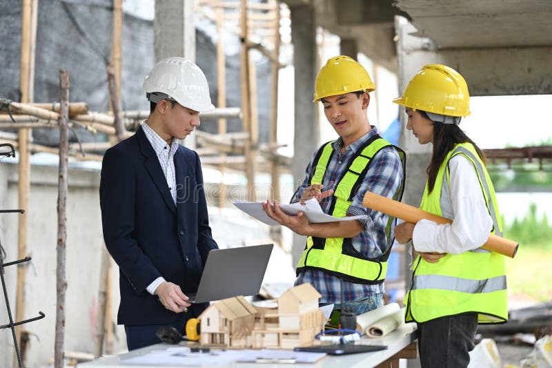 Male Project Manager and Engineers Discussing Project Details at ...