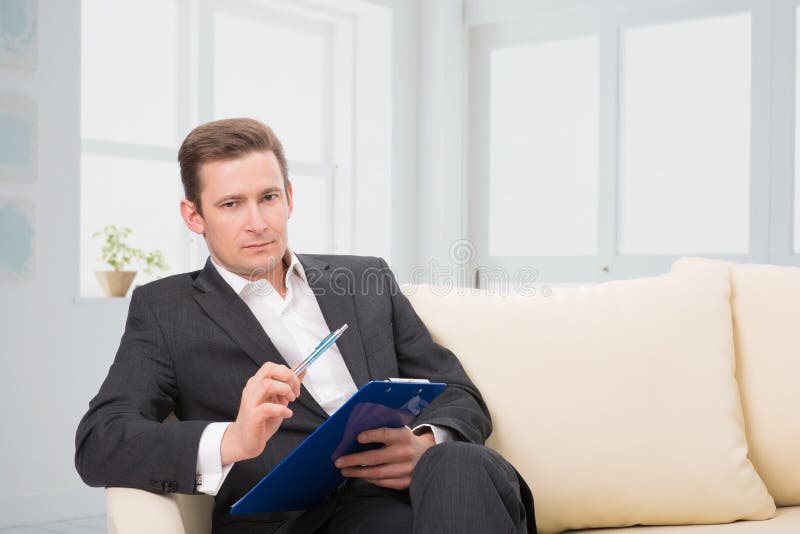 Male psychologist being ready to take notes - Stock Image - Everypixel