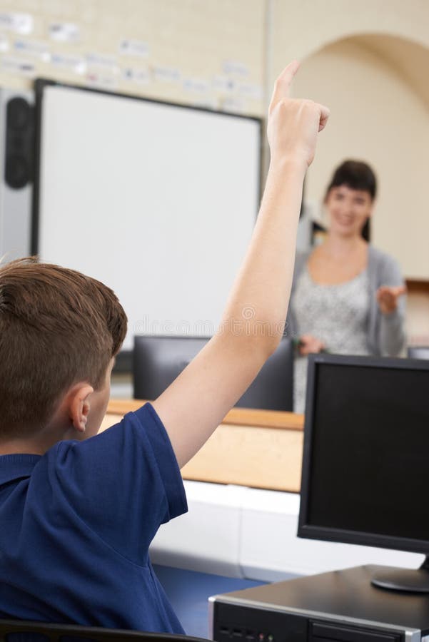 Male Pupil Answering Question in School Classroom Stock Image - Image ...